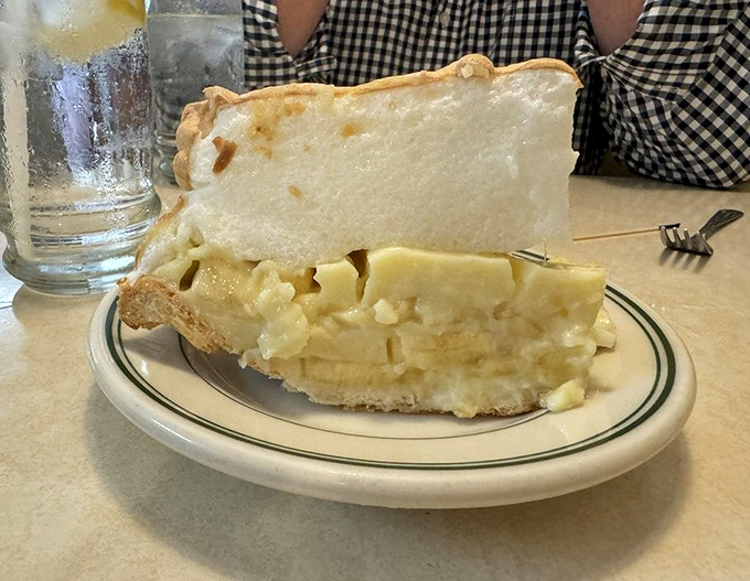 Banana cream pie so tall it needs its own zip code, topped with clouds of real whipped cream.