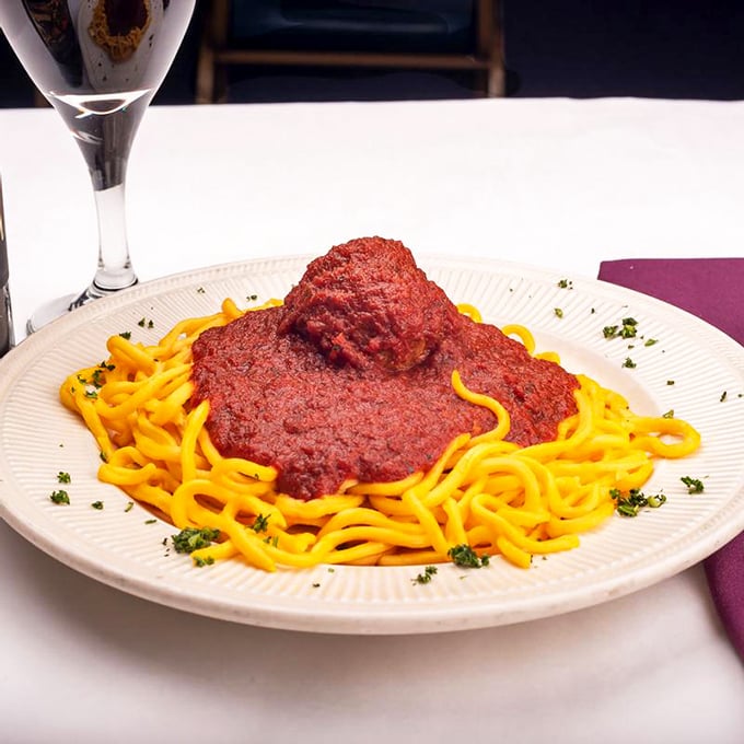 Spaghetti and meatball perfection &ndash; that vibrant sauce clinging lovingly to each strand of pasta while the meatball stands guard like a delicious sentry.