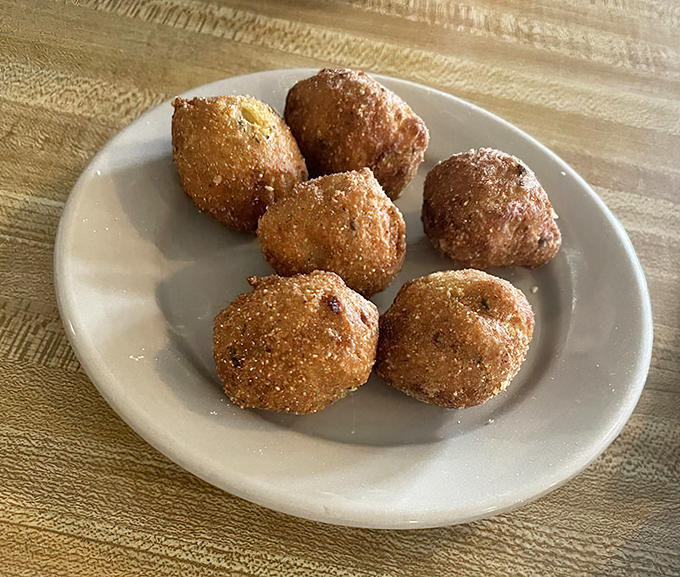Hush puppies so perfectly golden they'd make a Southern grandmother weep with joy. Crispy outside, tender cornmeal heaven inside.