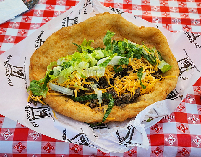 This isn't just a taco—it's edible architecture. The puffy fry bread creates a perfect foundation for that mountain of beef and fresh toppings.