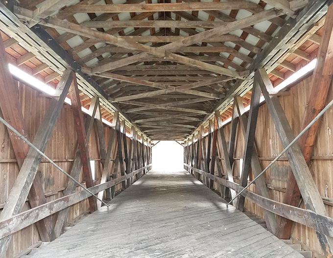 These wooden trusses showcase 19th-century engineering that puts some modern construction projects to shame, honestly.