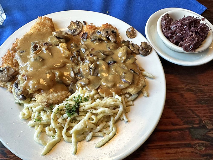 Jaeger Schnitzel: where crispy breaded pork meets mushroom gravy in a marriage made in culinary heaven. The spätzle looks ready to soak up every delicious drop.