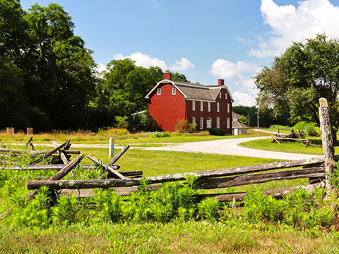 The historic red farmhouse at Johnston Farm stands proudly against Ohio's sky, looking like it stepped right out of an American history textbook.