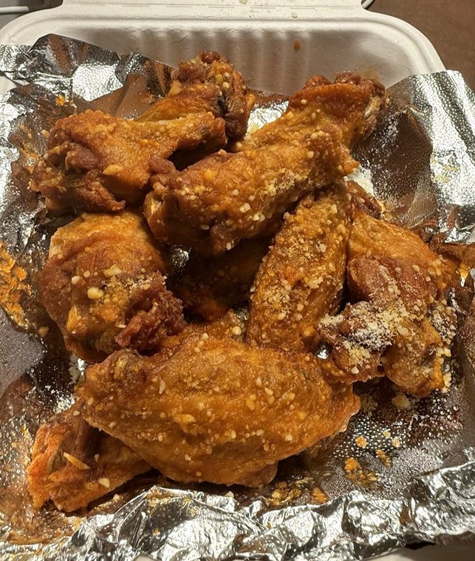 These wings aren't just crispy&mdash;they're wearing a garlic parmesan coating that could make angels sing and cardiologists frown simultaneously.