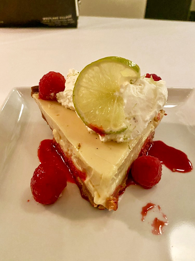Key lime pie that strikes that magical balance between tart and sweet&mdash;topped with fresh whipped cream and raspberries for a dessert that whispers "vacation."