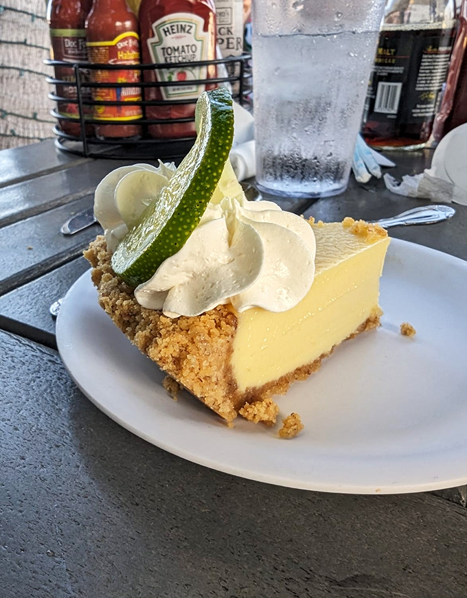Key lime pie that strikes the perfect sweet-tart balance. That graham cracker crust is holding more Florida sunshine than my retirement account.