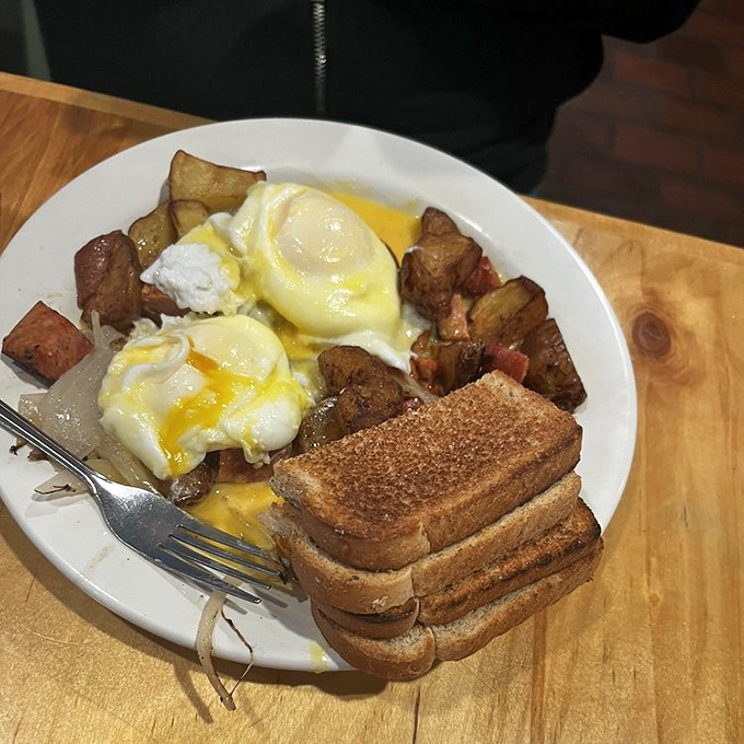 Breakfast alchemy: perfectly poached eggs crowning a mountain of potato-kielbasa hash&mdash;proof that Cleveland mornings start with serious flavor.