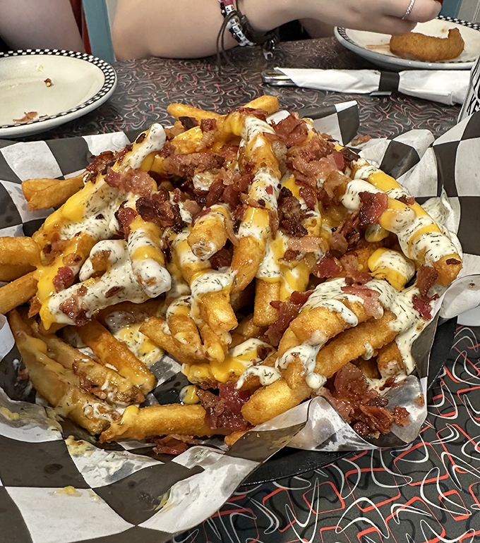 Loaded fries that require a game plan before eating. Cheese, bacon, and ranch create a fork-worthy masterpiece that laughs at the concept of "sharing."