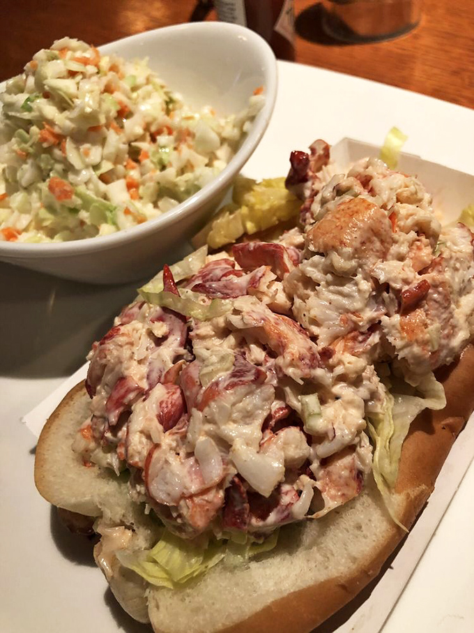The lobster roll arrives like a celebrity—overflowing with sweet meat, minimal dressing, and accompanied by coleslaw that doesn't feel like an afterthought.