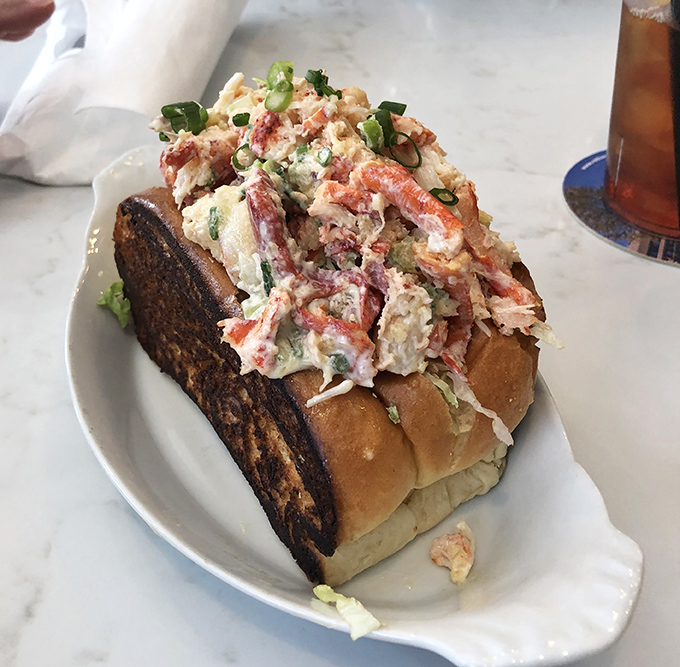 This lobster roll isn't just generous—it's practically philanthropic. The seafood-to-bread ratio here deserves its own mathematical theorem.