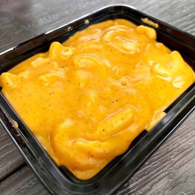 Mac and cheese that doesn't just complement the barbecue—it demands equal billing with its creamy, cheesy, slightly speckled perfection.