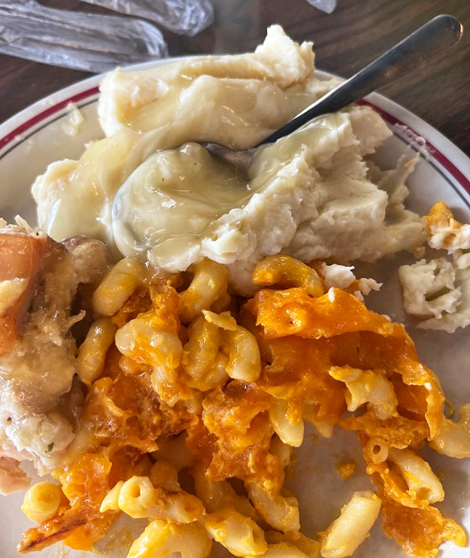 Comfort food geography: creamy mashed potato mountains beside cheesy mac and cheese valleys&mdash;a landscape worth exploring with every forkful.