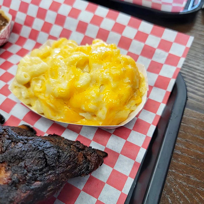 Mac and cheese so gloriously yellow and gooey, it could make a grown adult forget table manners and lick the paper basket clean.