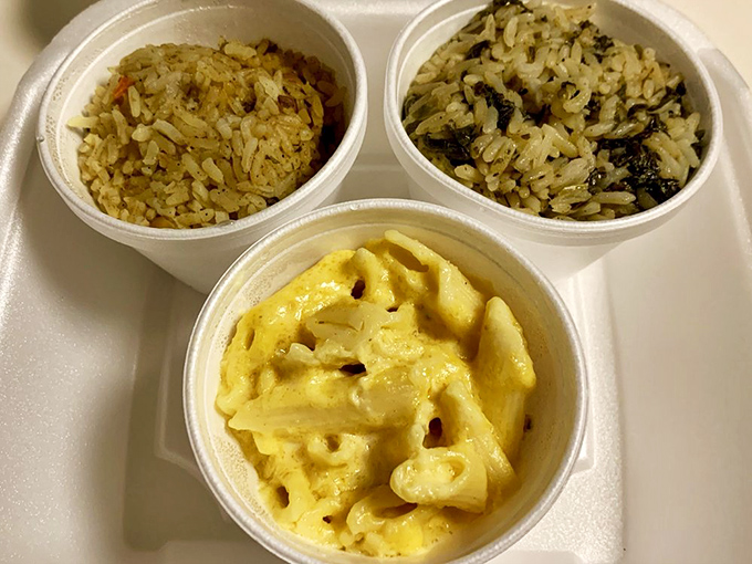 The holy trinity of sides: two variations of perfectly cooked rice flanking mac and cheese that's achieved that elusive balance between creamy and structured.