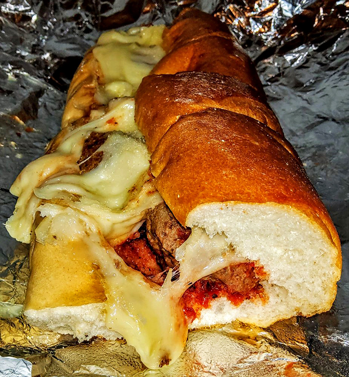 The Italian roll barely contains this meatball masterpiece, where melted cheese cascades over savory spheres of beef like a dairy waterfall.