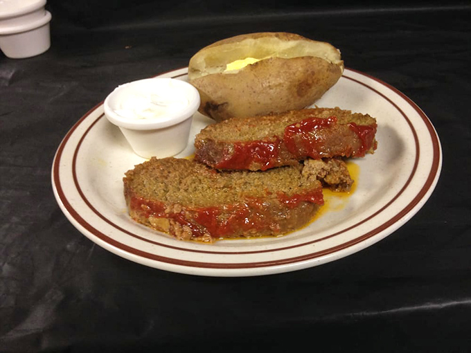 Hearty meatloaf, a buttery baked potato, and a side of sour cream&mdash;comfort food that feels just like home,