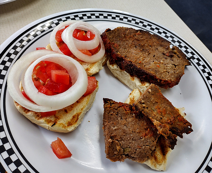 These meatloaf sliders aren't just sandwiches; they're childhood memories served on a bun with fresh tomatoes and onions standing by.