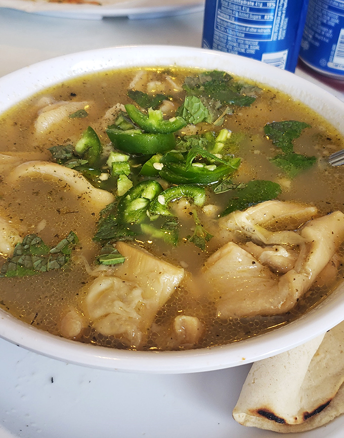 A bowl of menudo that cures what ails you—tender tripe, hominy, and a broth clear enough to see your weekend regrets reflected back at you.