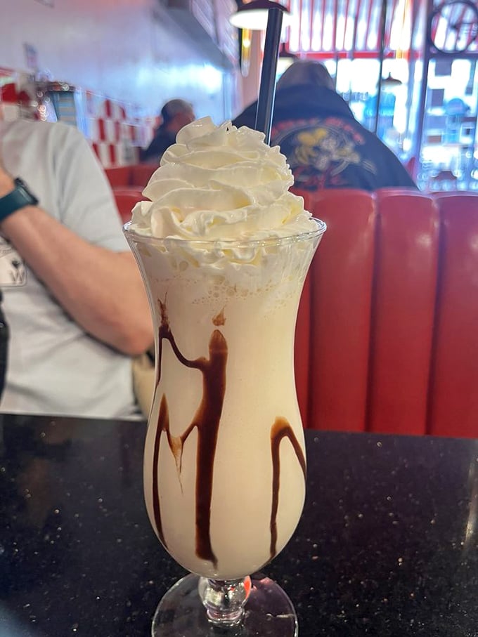 Milkshake architecture at its finest. That chocolate drizzle isn't random—it's abstract art that happens to taste like childhood memories.