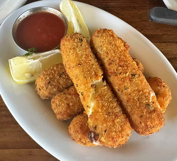 These aren't your freezer aisle mozzarella sticks. These golden-brown beauties reveal a perfect cheese pull that would make Instagram weep.