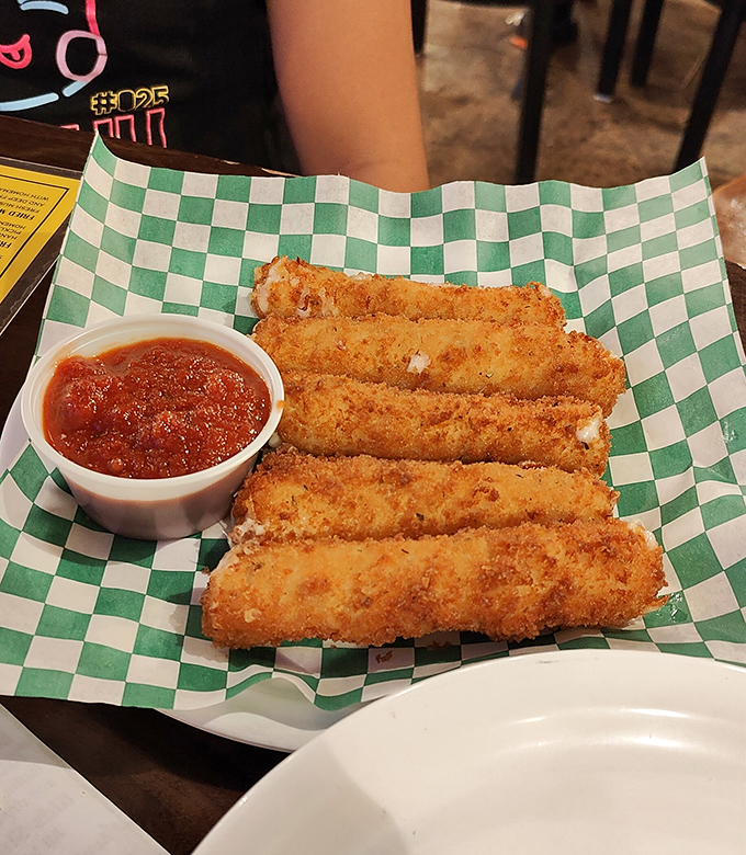These aren't just mozzarella sticks; they're golden wands of cheese magic that stretch dramatically with each pull, demanding their own slow-motion sequence.