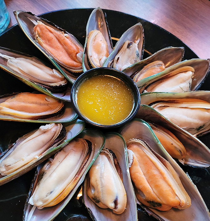Ocean treasures arranged like a sunburst around liquid gold butter&mdash;these mussels aren't just seafood, they're an event.