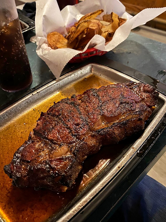 The New York Strip arrives like a sizzling monolith of meat, its juices creating a natural sauce that makes additional condiments seem like unnecessary meddling.