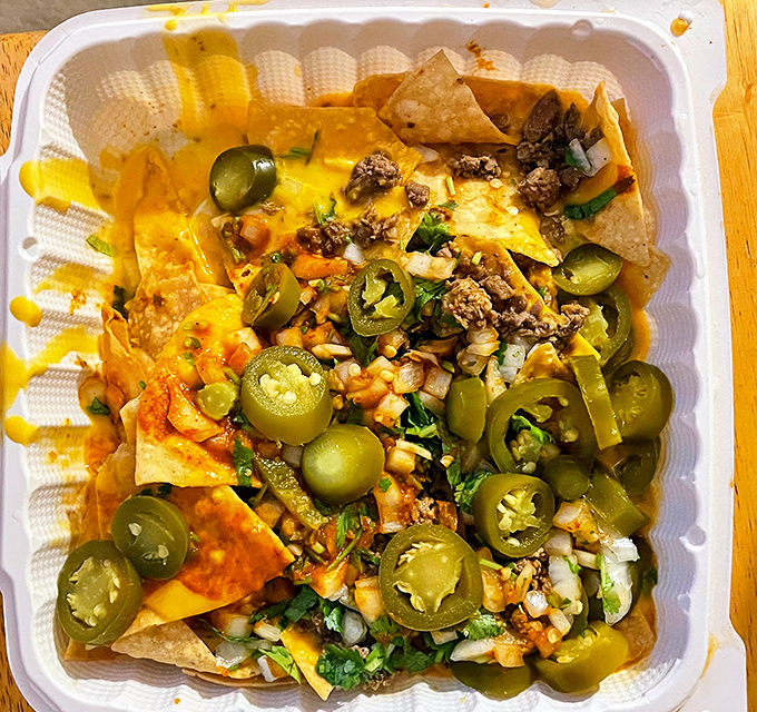 Nachos that laugh at sports stadium versions &ndash; loaded with jalape&ntilde;os, cheese, and meat in a symphony of textures that would make Mozart weep.