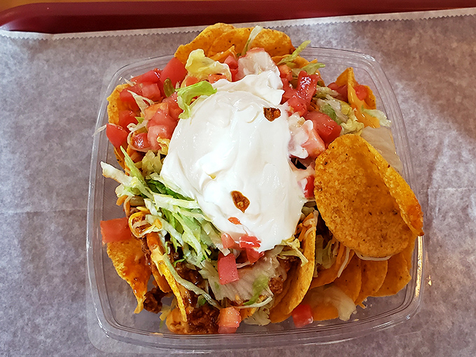 Nachos Supreme that doesn't need a passport to deliver authentic satisfaction. That sour cream dollop is the chef's kiss.