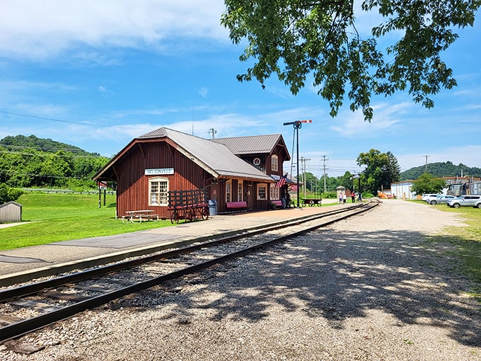 The charming Nelsonville depot stands as if from a model train set come to life, its rustic red boards having welcomed travelers for generations.