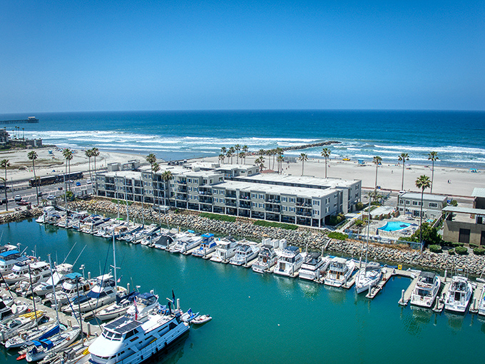 Where harbor meets ocean, creating a paradise for boaters and beachgoers alike. The marina's blue waters mirror California's perfect skies in this coastal sanctuary.