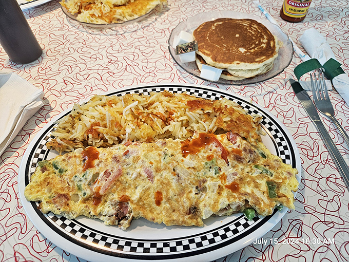 The omelet that launched a thousand road trips. Perfectly executed with hash browns that achieve the ideal crisp-to-tender ratio.
