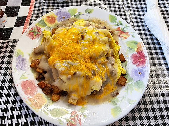 Behold the omelet that launched a thousand satisfied sighs. Cheese cascades over potatoes like a yellow waterfall of morning bliss.