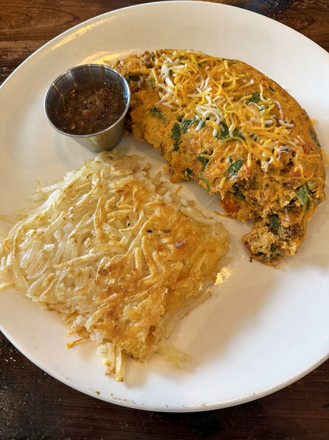 An omelet should be a canvas for creativity, and this colorful masterpiece paired with perfectly crisped hash browns is breakfast Picasso.
