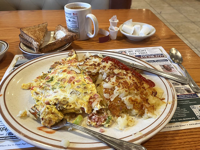 Breakfast perfection on a plate: a fluffy omelet meets crispy hash browns. The kind of morning fuel that makes Monday feel conquerable.