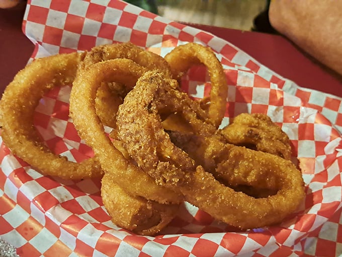 Golden-brown onion rings stacked like edible jewelry&mdash;crispy, light, and the perfect vehicle for whatever sauce catches your fancy.