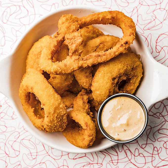Golden halos of happiness! These perfectly crisp onion rings with their secret-recipe batter deserve their own fan club.