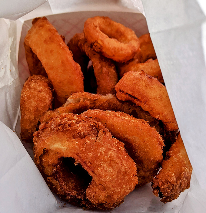 Golden-brown onion rings that crunch loud enough to drown out your inner voice saying "maybe I should eat a salad instead."