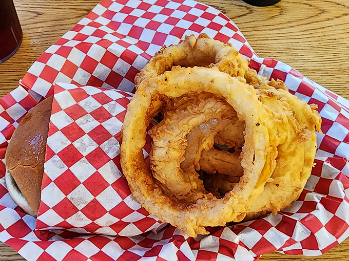 Golden onion rings that crackle with each bite, served on red-and-white checkered paper&mdash;the universal signal for "prepare to get happily messy."