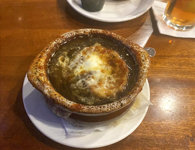 French onion soup that's achieved the golden trifecta: sweet caramelized onions, savory broth, and a cheese cap that stretches to the heavens.