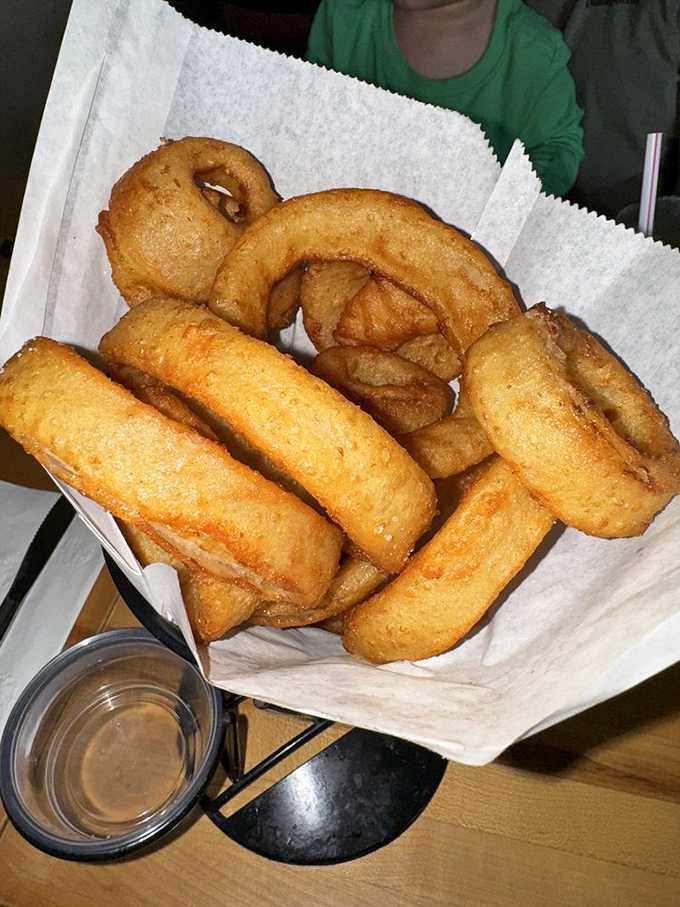 Golden onion rings that crunch like autumn leaves &ndash; except instead of yard work, you get dipping sauces and happiness.