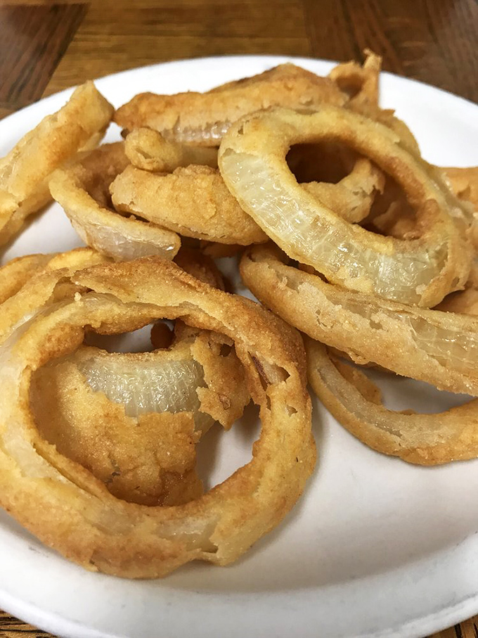The legendary onion rings in all their golden glory. Crispy, substantial, and engineered with the perfect batter-to-onion ratio—a masterclass in simplicity.