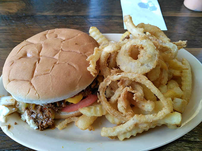 The holy trinity of diner perfection: a juicy burger, golden fries, and onion rings with just the right crunch-to-tenderness ratio. Diet starts tomorrow, folks.