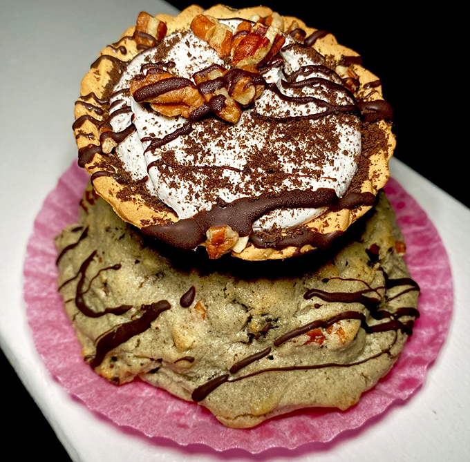 Pecan pie gets the VIP treatment with whipped cream, chocolate drizzle, and enough nuts to make a squirrel consider breaking in after hours.