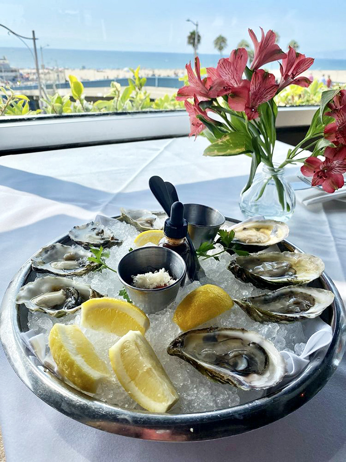 Fresh oysters on ice with a view that makes you wonder: is it the mignonette or the Pacific panorama that enhances the flavor?