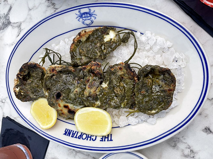 Oysters Rockefeller looking like emerald-crowned jewels of the sea. Spinach never had such distinguished company.