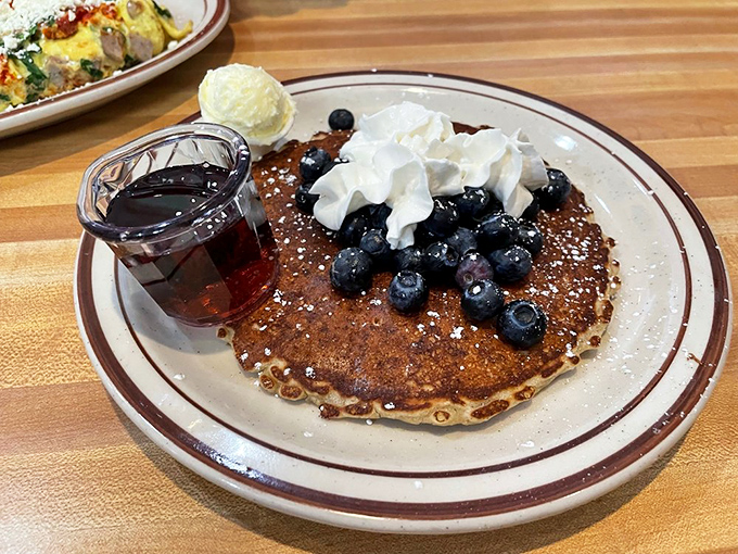 Blueberry pancakes crowned with whipped cream that would make your grandmother weep with joy and envy.