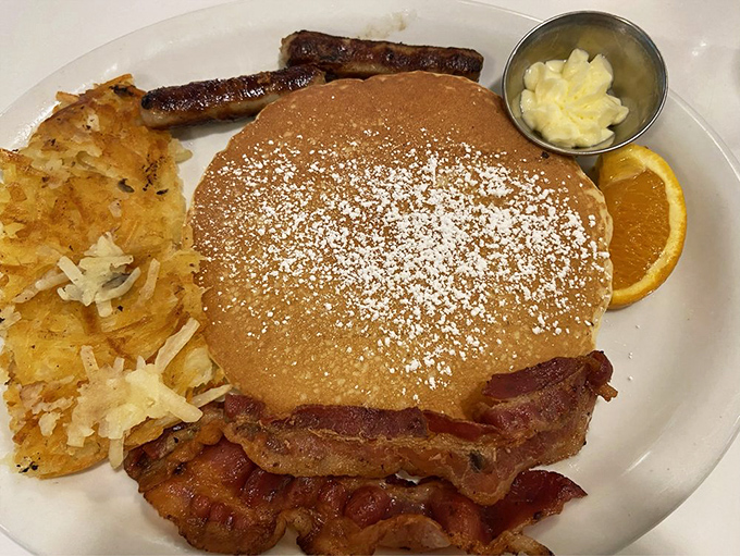 Pancakes dusted with powdered sugar snow, flanked by crispy bacon sentinels&mdash;breakfast doesn't get more American than this golden disc of morning joy.