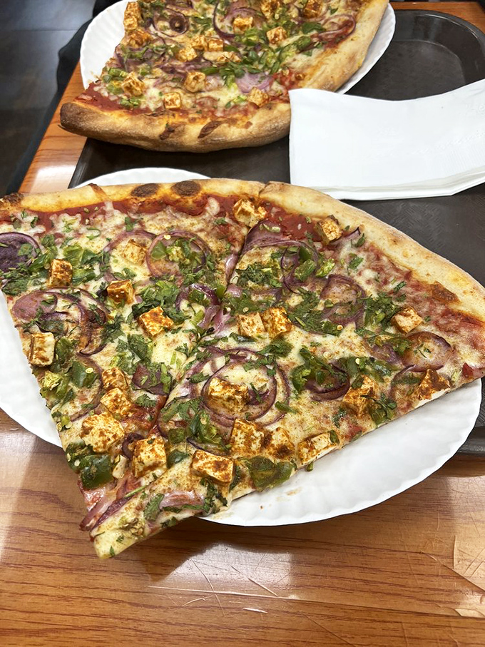 Paneer, red onions, and cilantro transform ordinary pizza into something extraordinary. Like finding out your favorite band just released a surprise collaboration album.