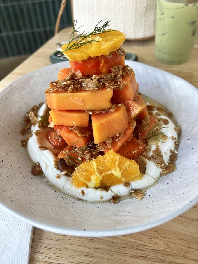 Papaya transformed into an architectural marvel. This isn't just fruit &ndash; it's a sweet, tangy revelation balanced atop yogurt like nature's most delicious Jenga game.